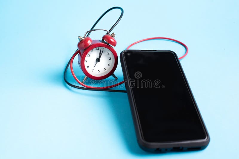 Mobile Phone and Alarm Clock Stock Photo - Image of metal, clock: 241496872