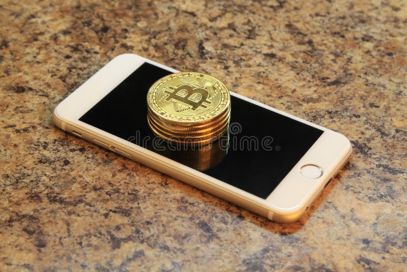Mobile Phone with Bitcoin Cryptocurrency Coins on the Granite Ta Stock ...