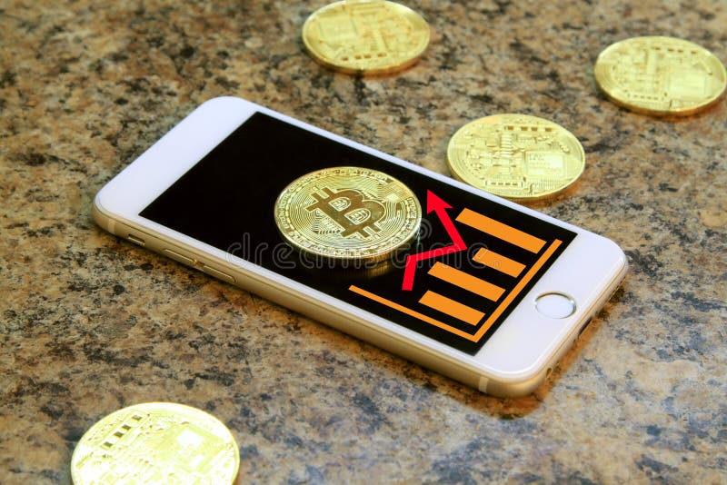 Mobile Phone with Bitcoin Cryptocurrency Coins on Granite Ta Stock ...