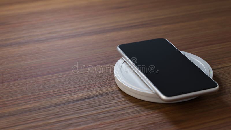 Mobile Phone Charging Battery with Wireless Charger on Working Table ...