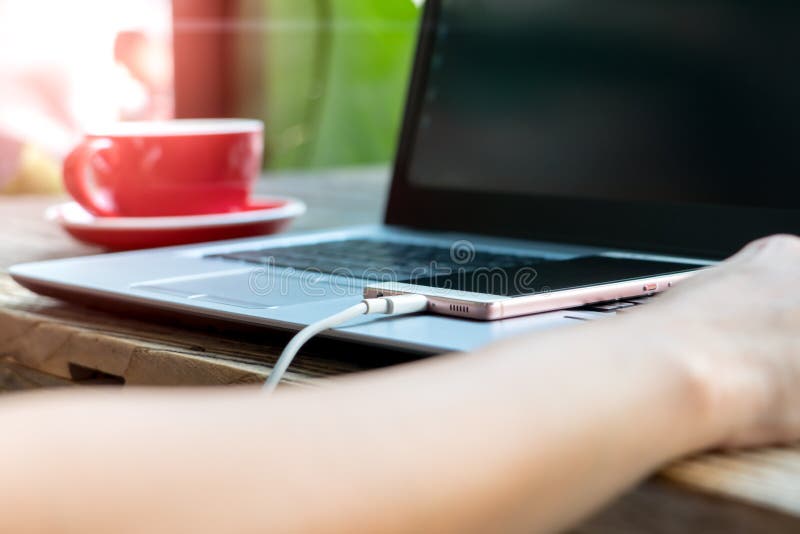 Mobile Phone is Charging on the Laptop, Communication Device Stock ...