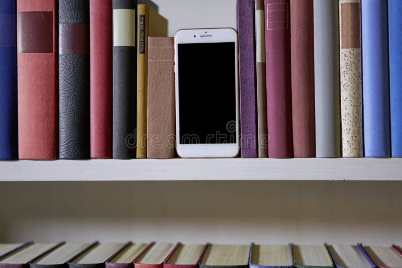Mobile Phone between Colourful Books in a Shelf Stock Photo - Image of ...