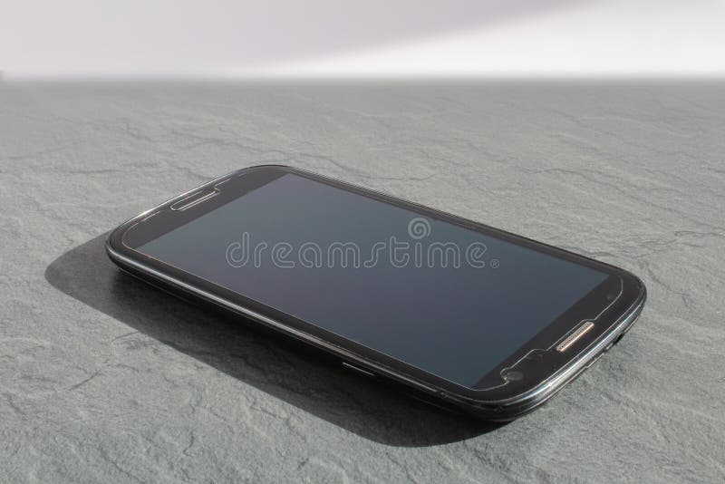 Mobile Phone on Dark Grey Stone Texture Stock Photo - Image of holding ...