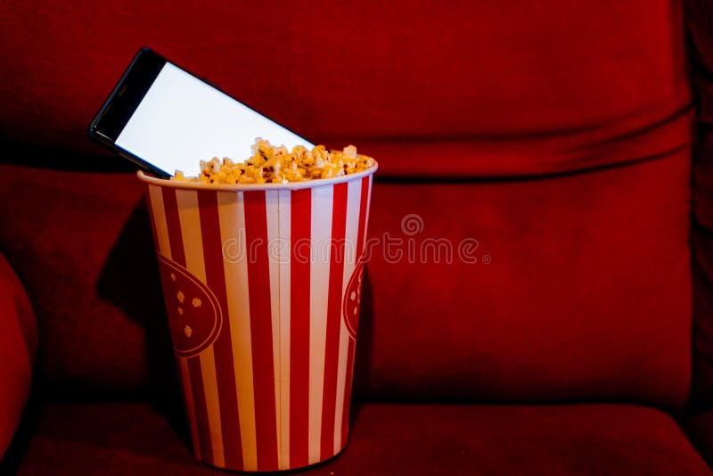 Mobile Phone with Empty White Bright Screen with Popcorn Bucket on the ...