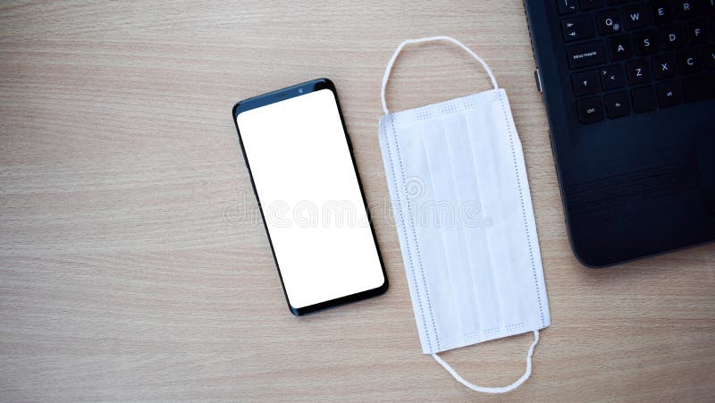 Mobile Phone with Face Mask on the Workspace of the Work Table. Stock ...