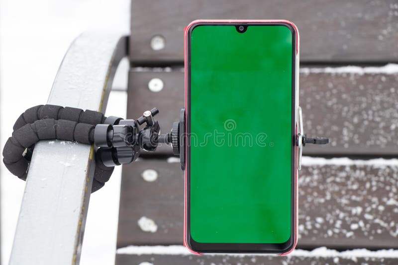 Mobile Phone with a Green Screen Fixed on a Flexible Stand on the ...