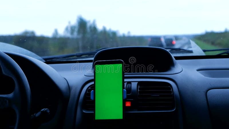 Mobile Phone with a Green Screen Inside a Car Parked on the Side of the ...