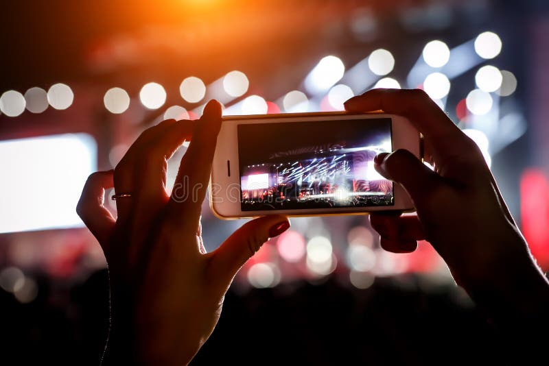 Mobile Phone in Hands at a Music Show. Using a Smartphone Concept Stock ...
