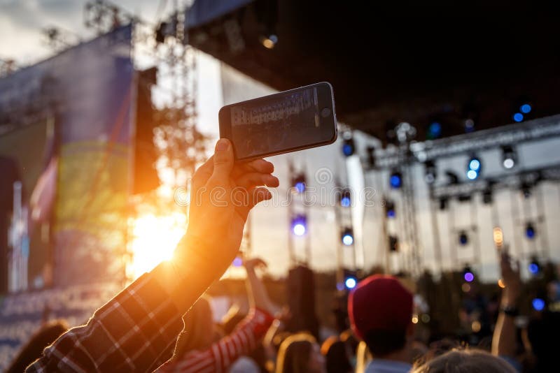 Mobile Phone in Hands at a Music Show. Using a Smartphone Concept Stock ...