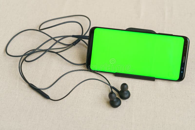 Mobile Phone and Headphones are on Table Stock Image - Image of display ...