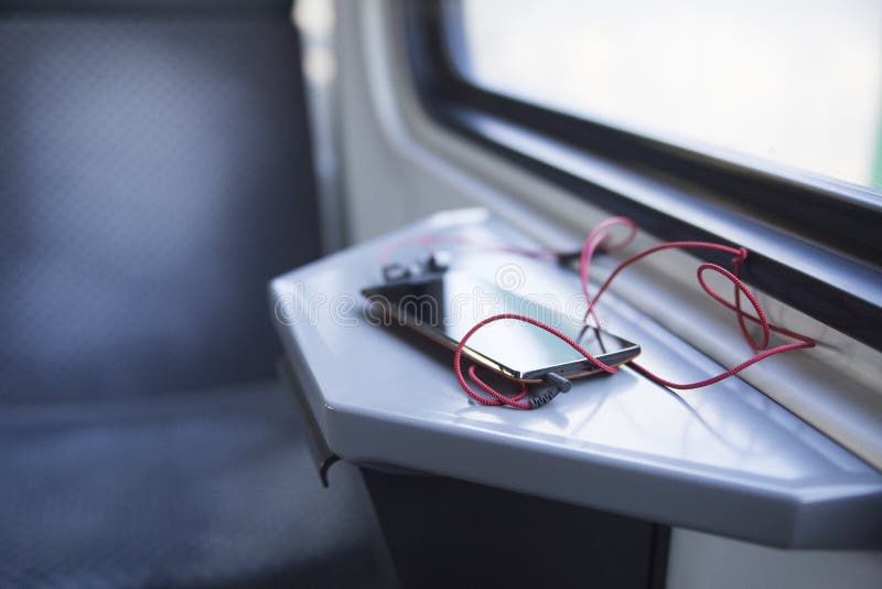 Mobile Phone and Headset on the Table in a Train Stock Photo - Image of ...
