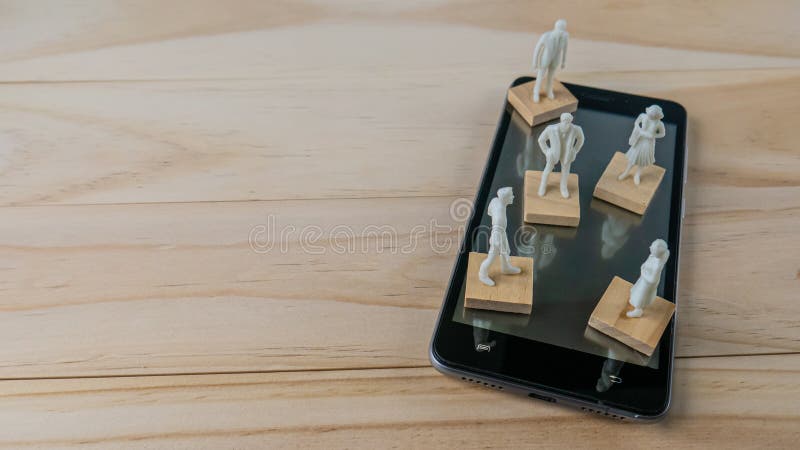Mobile Phone and Human Figure on Wood Table for Communication Content ...