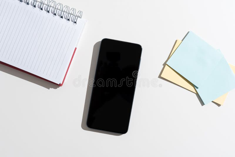 Mobile Phone with Important Message on Desk with Empty Notebook and ...