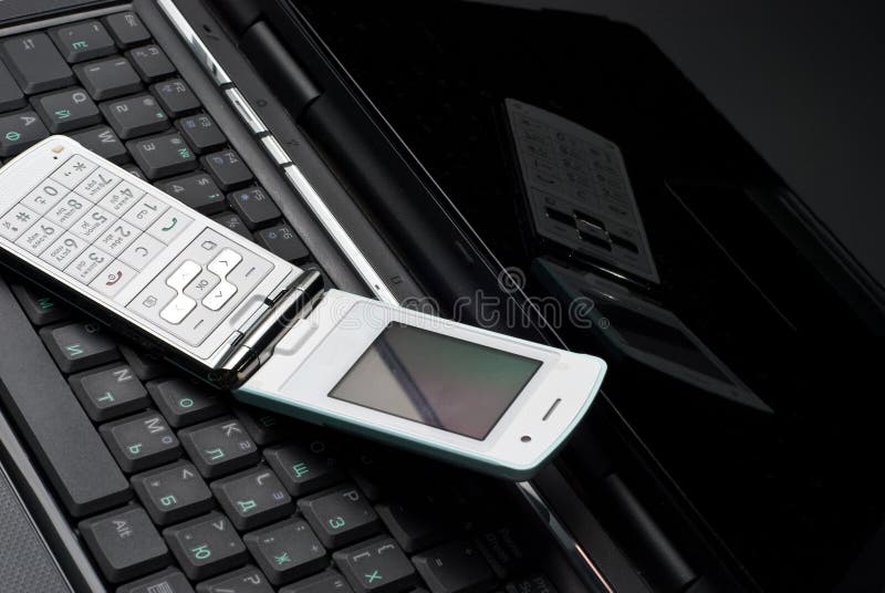 Mobile phone on a laptop stock photo. Image of modern - 12891644