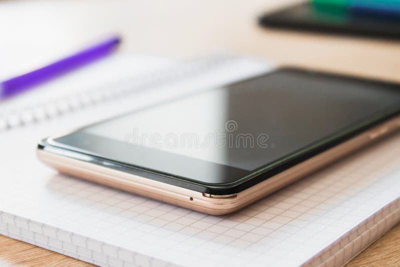 A Mobile Phone and a Notebook are on the Table Stock Image - Image of ...