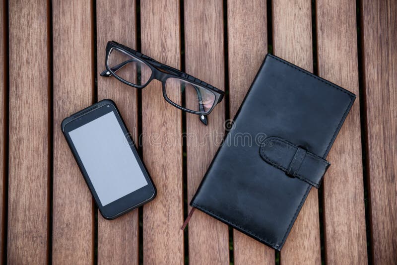 Mobile Phone, Notepad, Glasses on Wooden Table. Stock Image - Image of ...