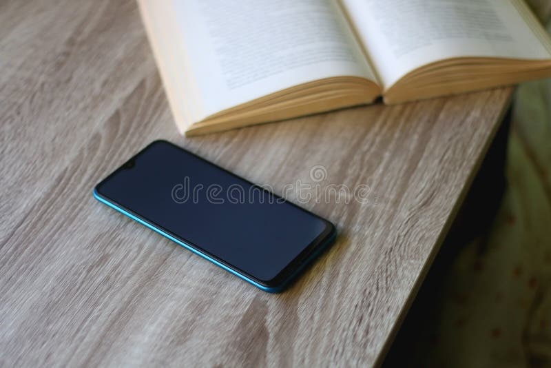 Mobile Phone and Open Book stock image. Image of device - 258988203