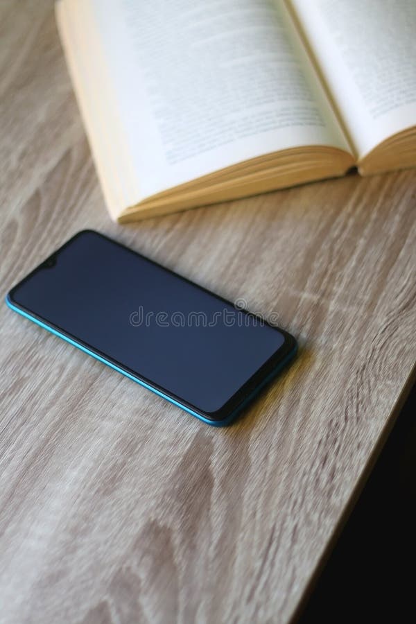 Mobile Phone and Open Book stock photo. Image of blank - 258988214