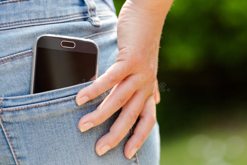 Mobile phone in pocket stock photo. Image of hand, pick - 78103086