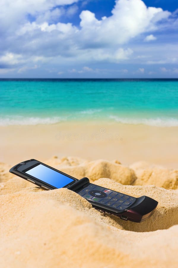 Mobile phone on sand beach stock image. Image of cell - 12207691