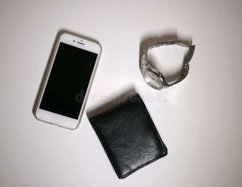 Mobile Phone, Wallet and Watch on the Table. Accessories for the Stock ...