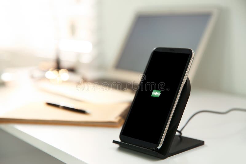 Mobile Phone with Wireless Charger on Table. Modern Workplace Accessory ...