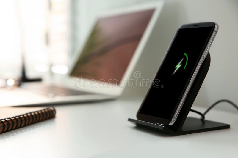 Mobile Phone with Wireless Charger on White Table. Modern Workplace ...
