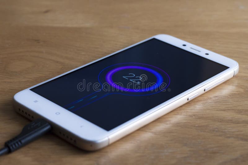 Mobile Phone on a Wooden Table Connected To a Charger Stock Photo ...