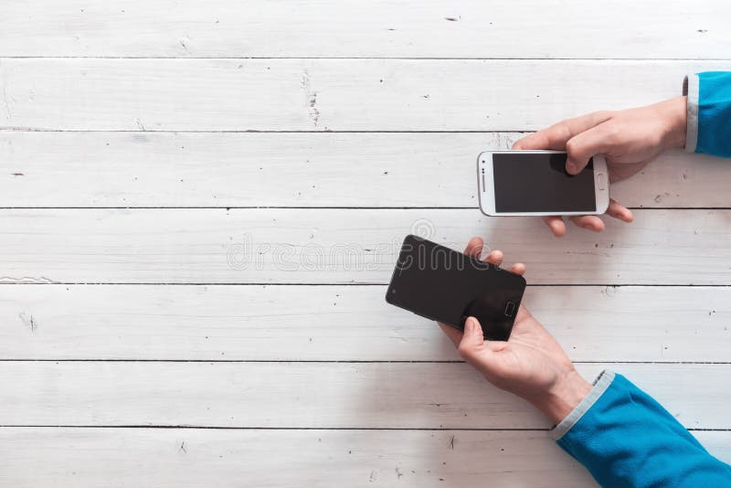 Mobile phones in hands stock photo. Image of cellphone - 93817050