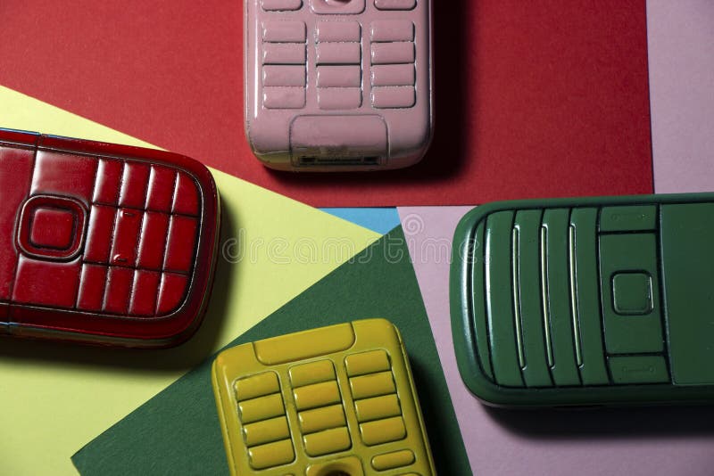 Mobile Phones in Various Colors with Multicolored Wallpaper Stock Image ...