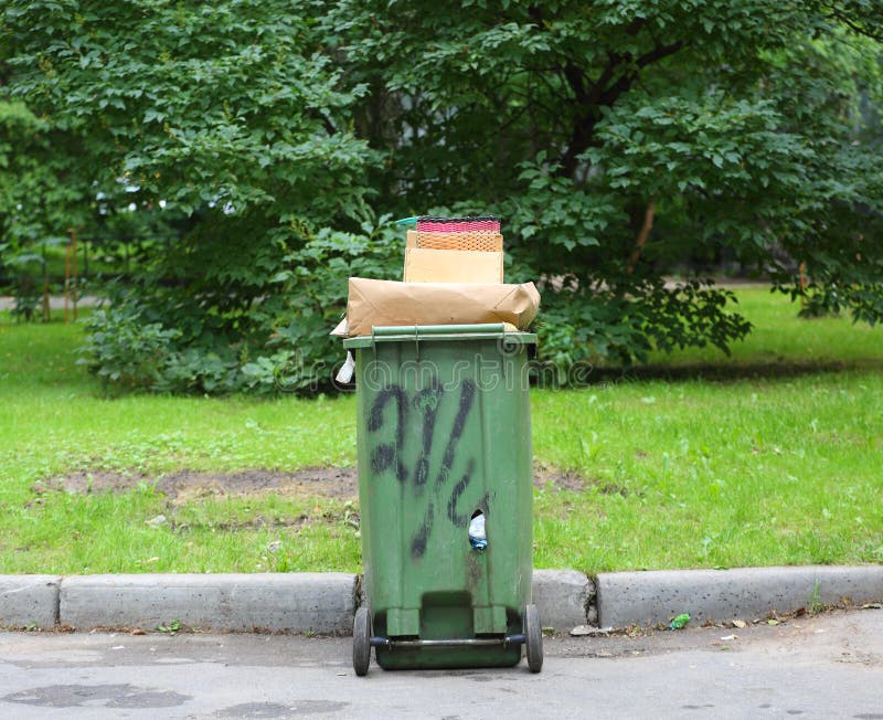 Mobile Plastic Green Container with Garbage is Standing by the Green ...