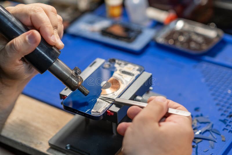 Mobile Repair Service, Technician Replacing the Back Glass of a ...