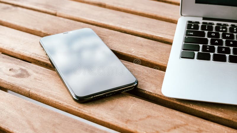 Mobile Smart Phone and Laptop Computer on Balcony Desk in Working from ...
