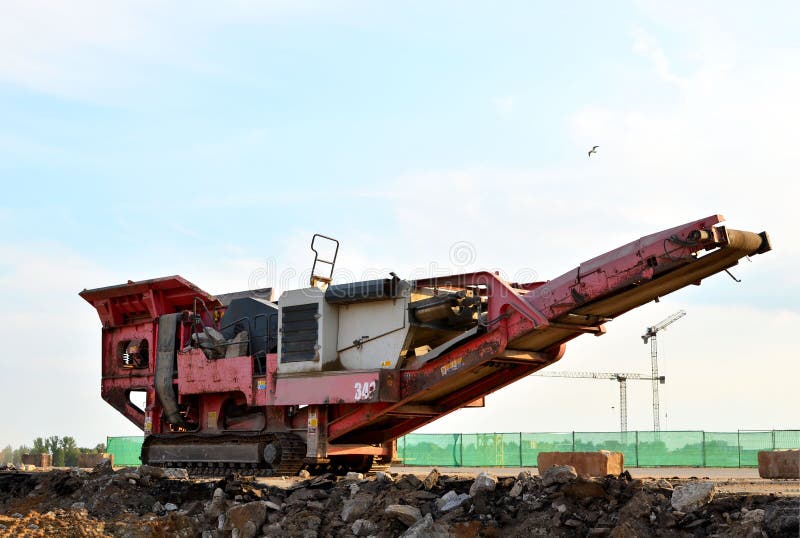 Mobile Stone Jaw Crusher Machine and Excavator during Crushing Concrete ...