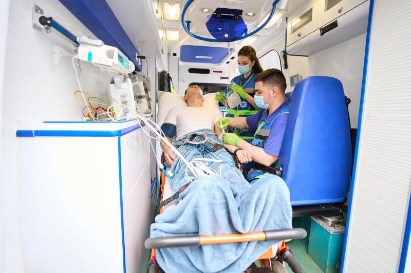 Mobile Team of Paramedics Connects the Patient To the Drip Stock Photo ...