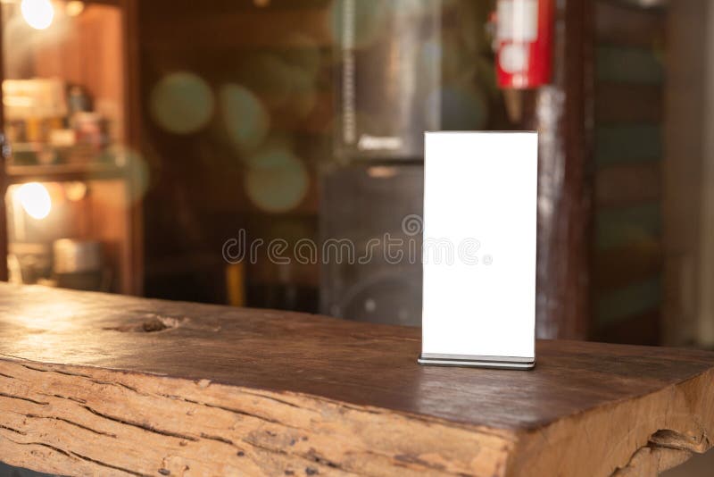 Mock Up Menu Frame Standing on Wood Table in Coffee Shop. Stock Photo ...