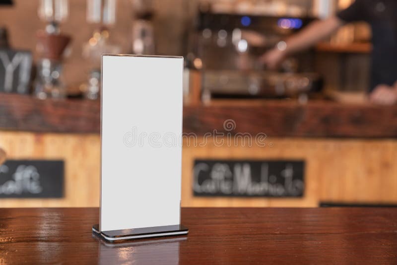 Mock Up Menu Frame Standing on Wood Table in Coffee Shop. Stock Photo ...