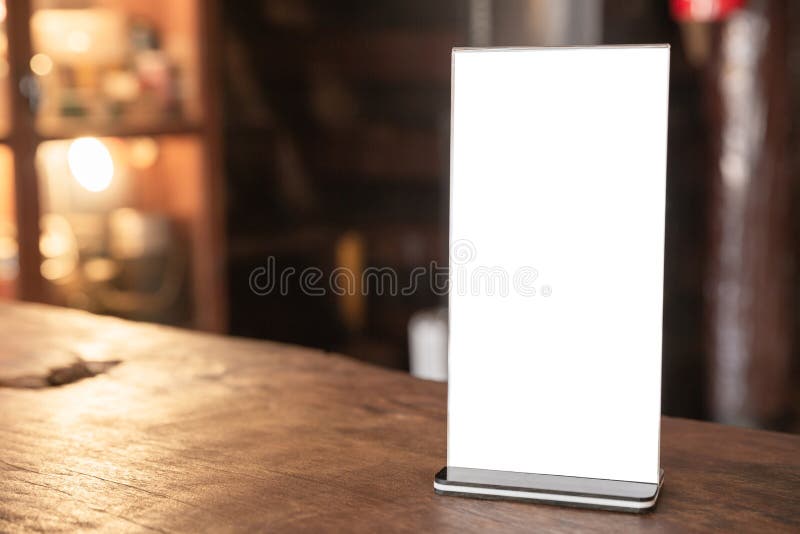 Mock Up Menu Frame Standing on Wood Table in Coffee Shop. Stock Photo ...