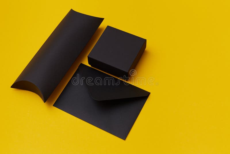 Mock Up of Two Black Paper Present Boxes and an Envelope on the Yellow ...