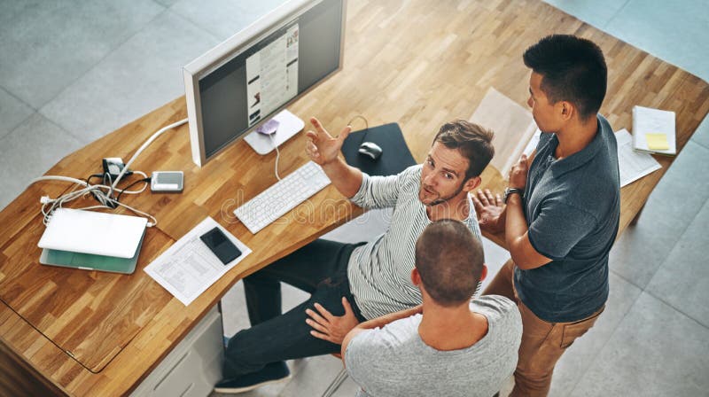 Mocking Up Design Ideas. High Angle Shot of Three Designers Working ...