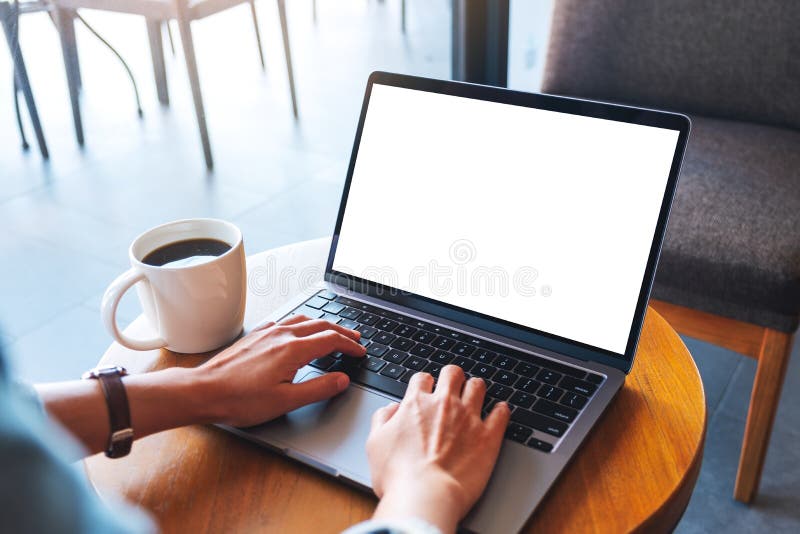 A Hand Typing on Laptop Computer with Blank White Desktop Screen on the ...