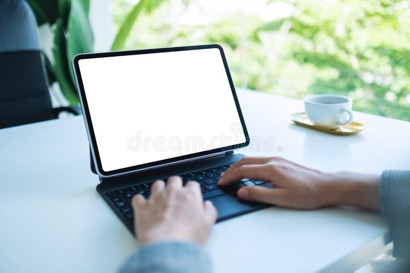 A Woman Using and Typing on Tablet Keyboard with Blank White Desktop ...
