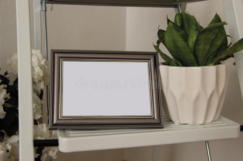 The Mockup of the Metallic Photo Frame and Flower Pot Stand on the ...