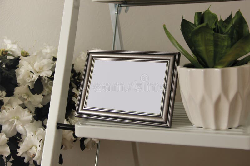 The Mockup of the Metallic Photo Frame and Flower Pot Stand on the ...