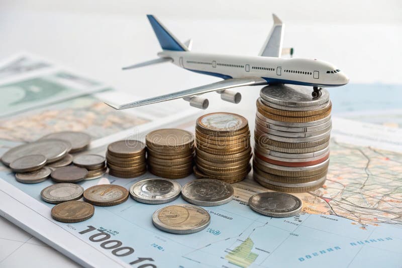 A Model Airplane Sits on a Stack of Coins, Symbolizing Travel Expenses ...