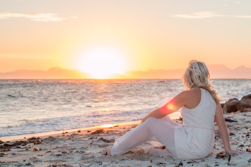 Model on beach at sunset stock photo. Image of mountains - 74813230