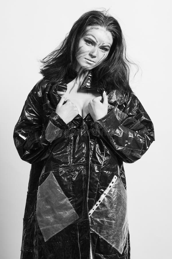 Model in a Black Raincoat Made of Cellophane and in Creative Make-up ...