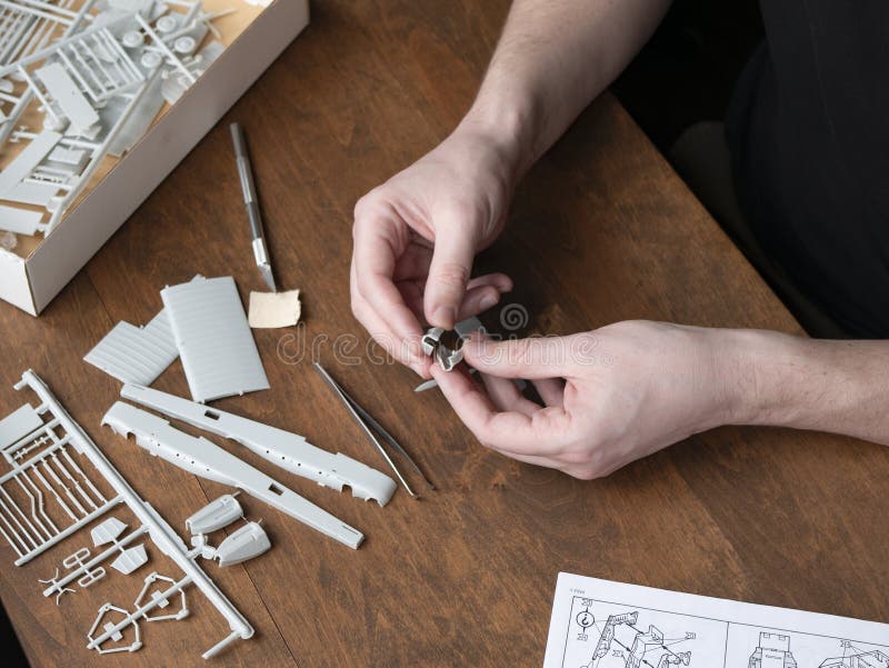 Model Builder Puts Plastic Fuselage Pieces Together. Stage of Plastic ...