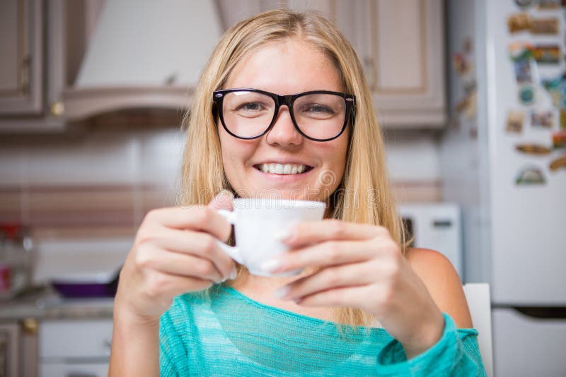 Model with cup in kitchen stock image. Image of green - 88617367