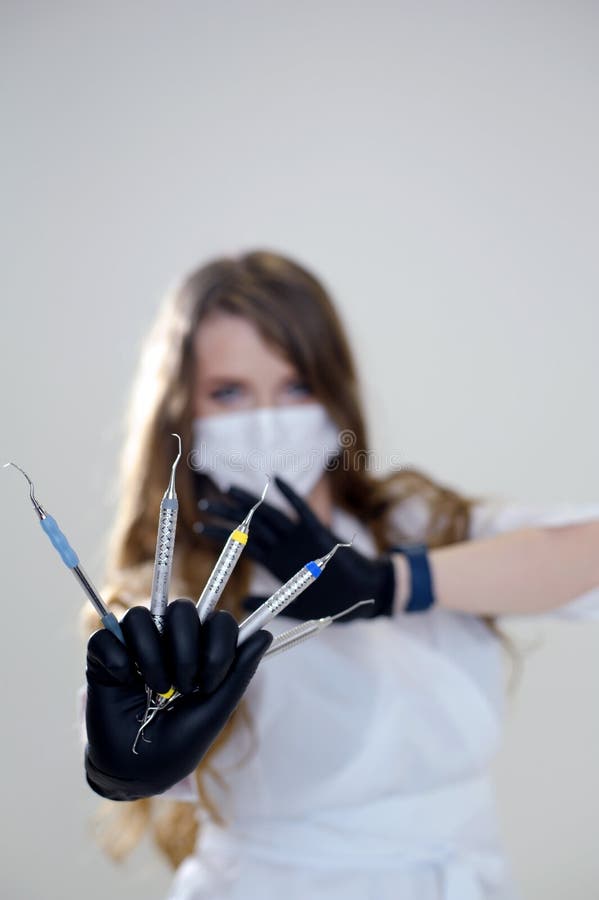 Model of Dentures and Dental Instruments in Hands of Dentist. Dental ...